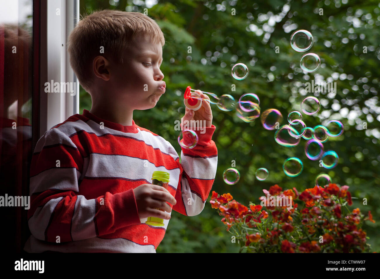 portrait of a young boy blowing bubbles Stock Photo - Alamy