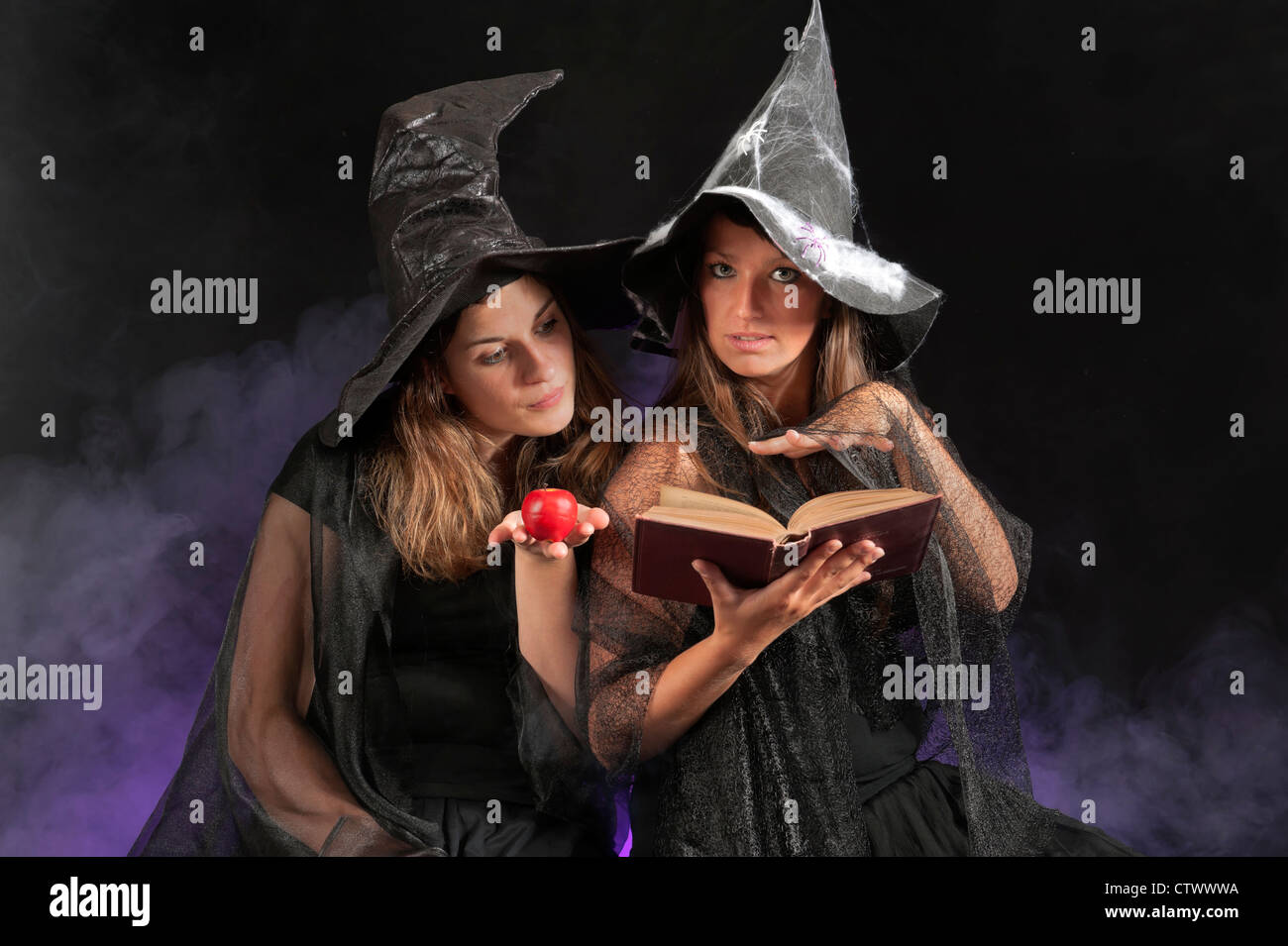 two halloween witches on dark smoke background Stock Photo - Alamy