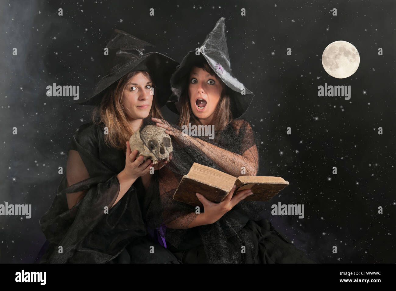 two halloween witches on dark smoky background Stock Photo - Alamy