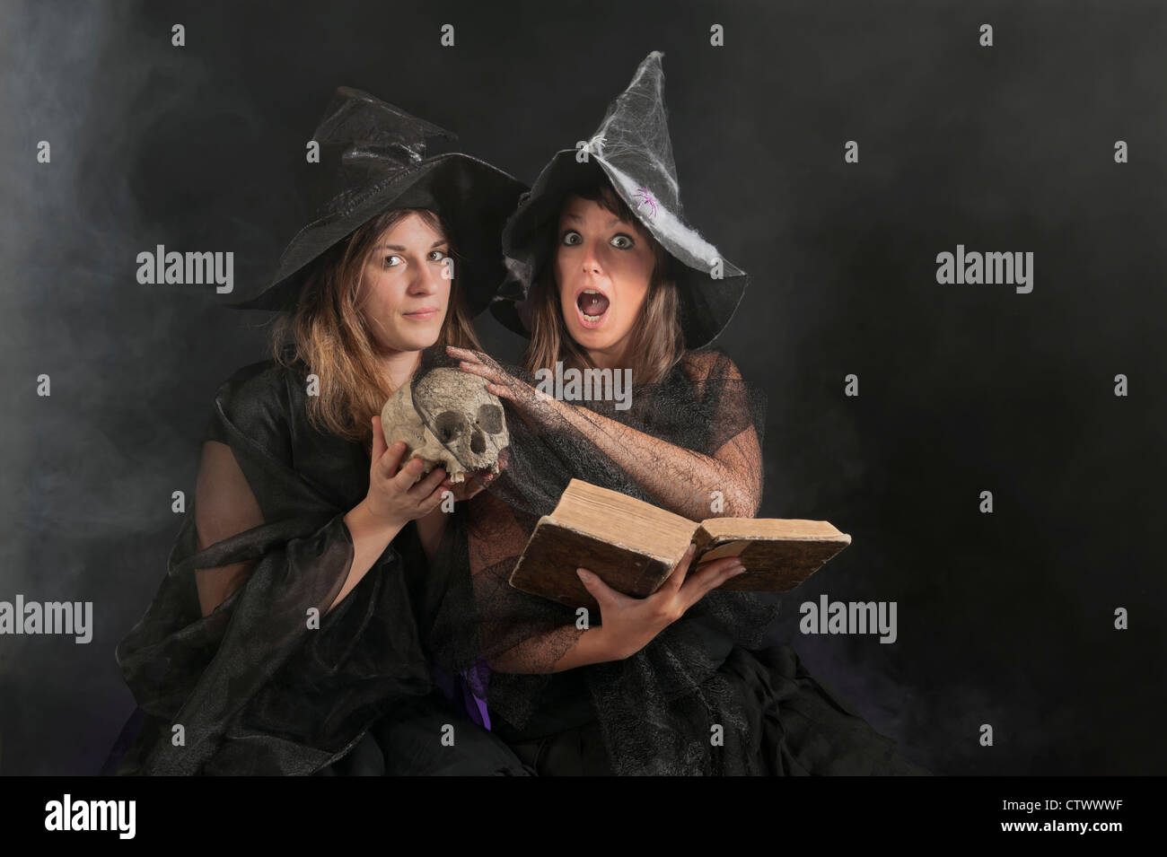 two halloween witches on dark smoky background Stock Photo - Alamy