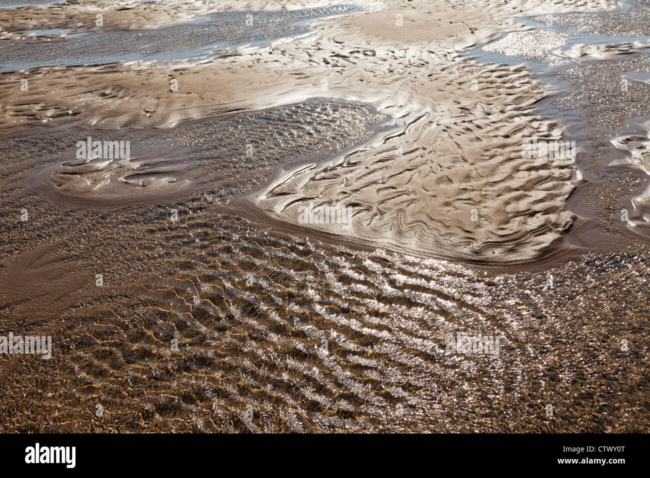 Sand patterns and the incoming tide at Bantham, Devon Stock Photo - Alamy
