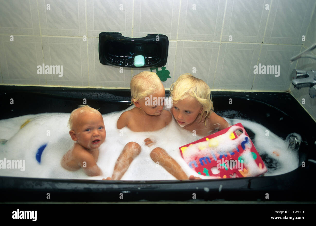 Children in a bathtub with bubbles hi-res stock photography and images ...
