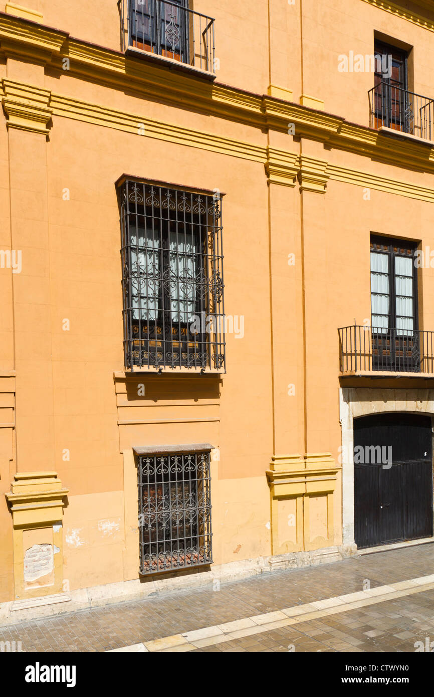 Typical old style Spanish building painted yellow Stock Photo - Alamy