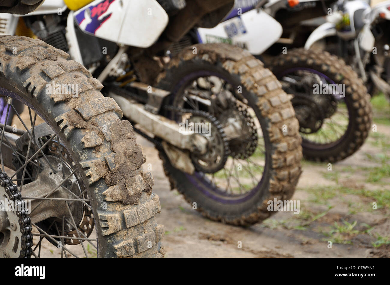 Rear motocross motorcycle wheels lined up Stock Photo - Alamy