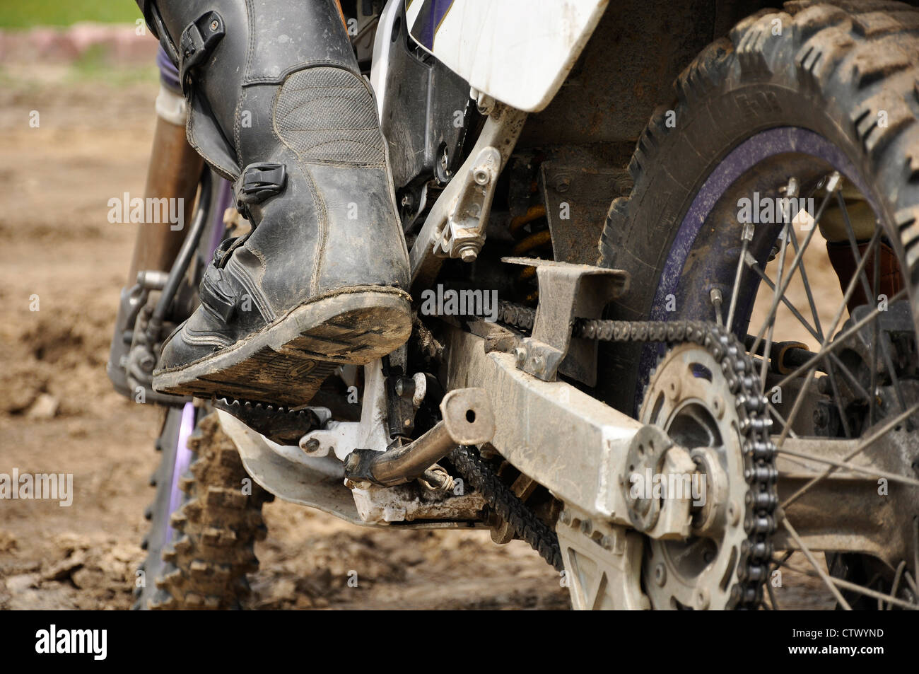 Motocross bike and rider's boot Stock Photo - Alamy