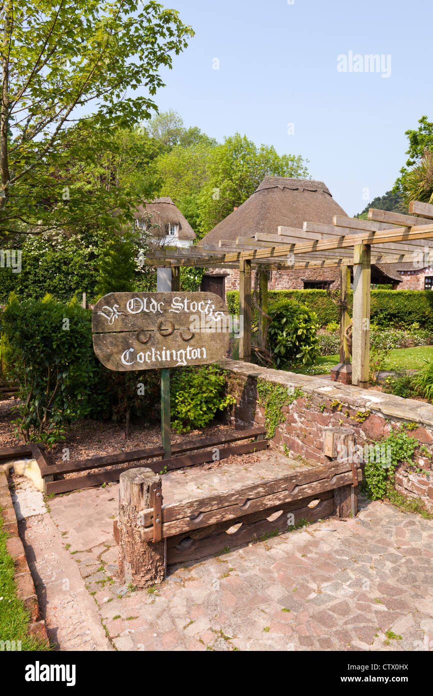 The old village stocks in the village of Cockington, Devon UK Stock ...