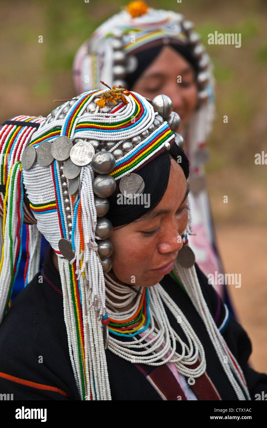 Women of the AKHA tribe wear headdresses made of beads, silver coins ...