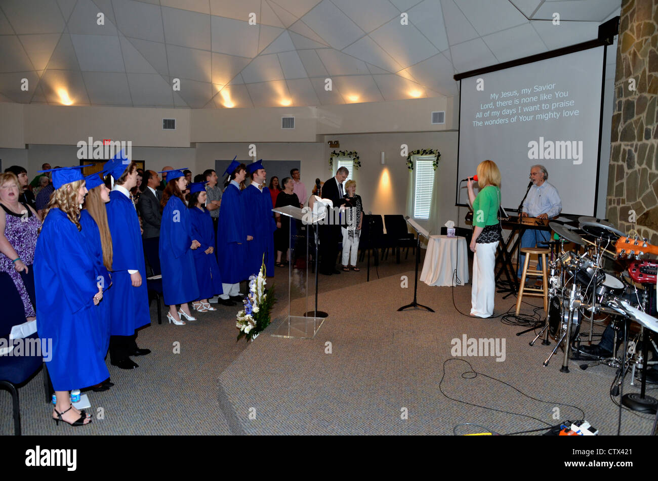High school graduates with their diplomas at a graduation ceremony ...