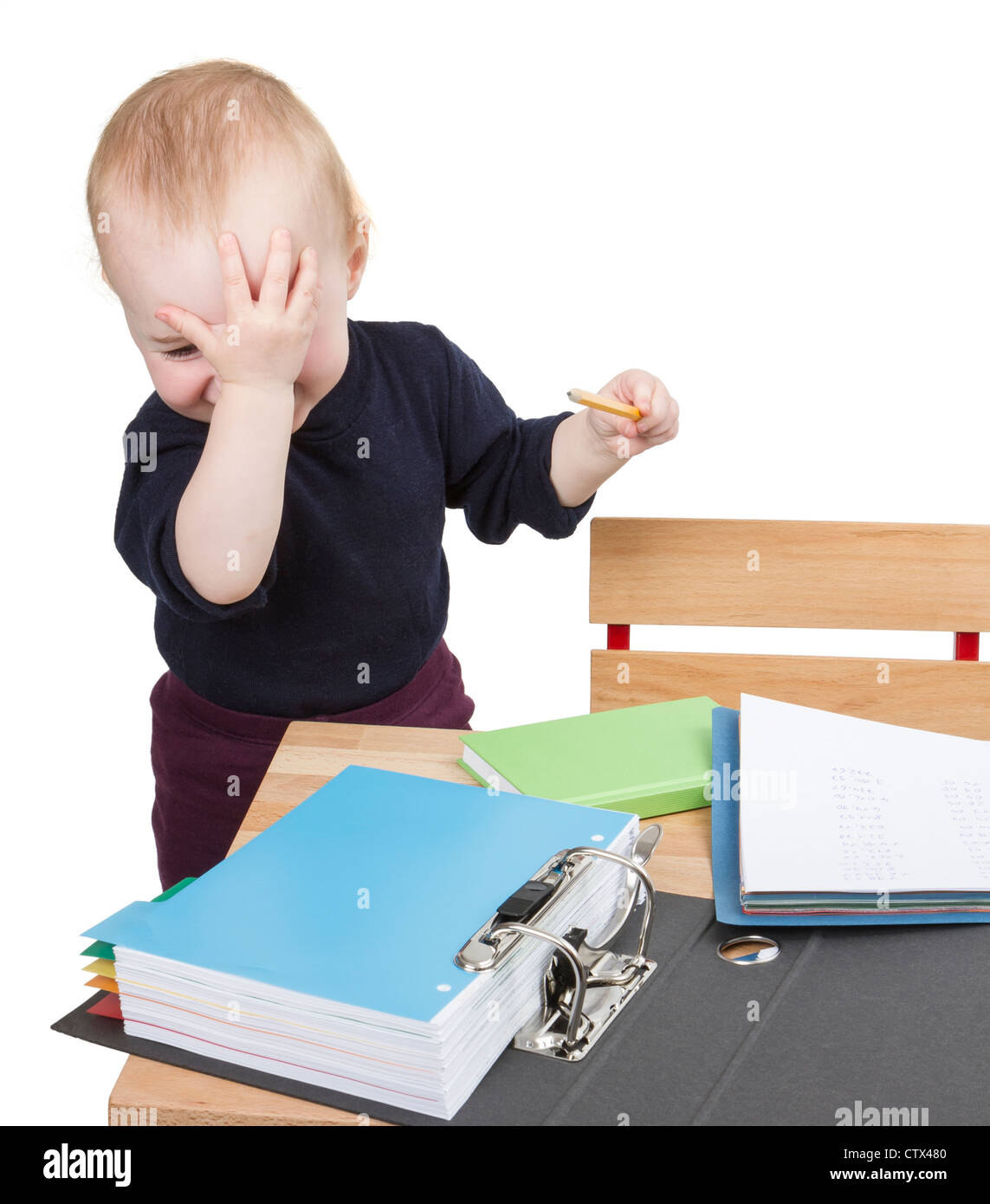 young child working at writing desk in light background Stock Photo - Alamy