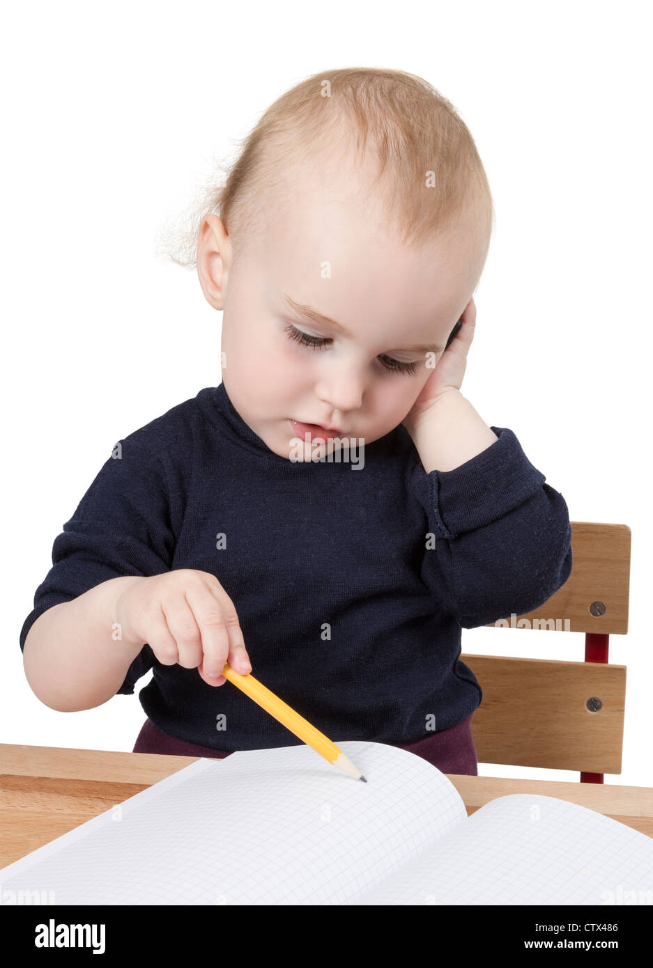 young child working at writing desk in light background Stock Photo - Alamy