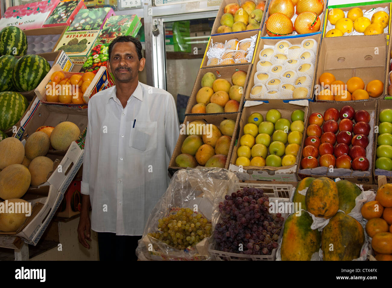Fruits and vegetables merchant at his shop at the green market in ...