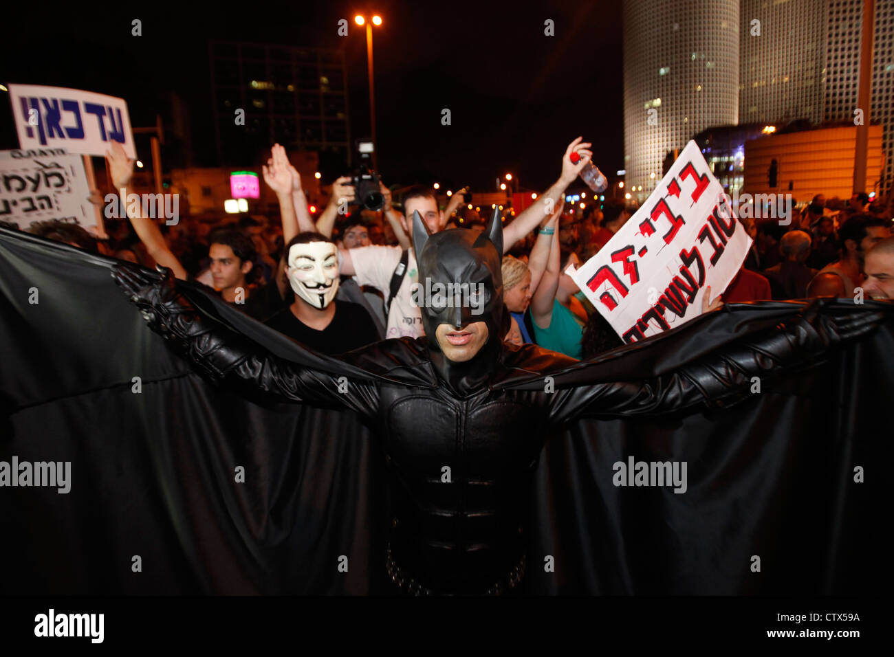 An Israeli demonstrator dressed in Batman outfit takes part in the Cost ...