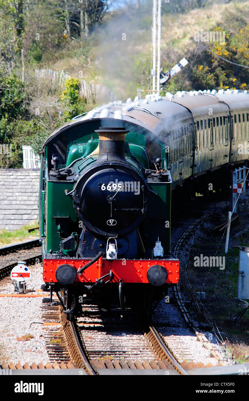 Steam train arriving at Corfe Castle station, Dorset, UK Stock Photo ...