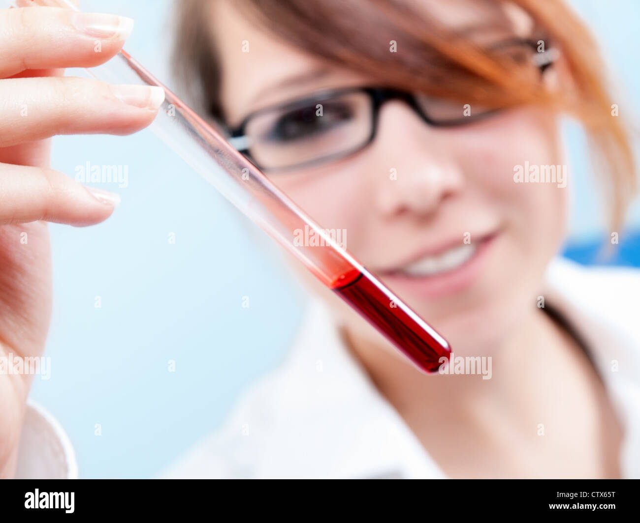 Laboratory assistant with a sample of blood in a test tube Stock Photo ...