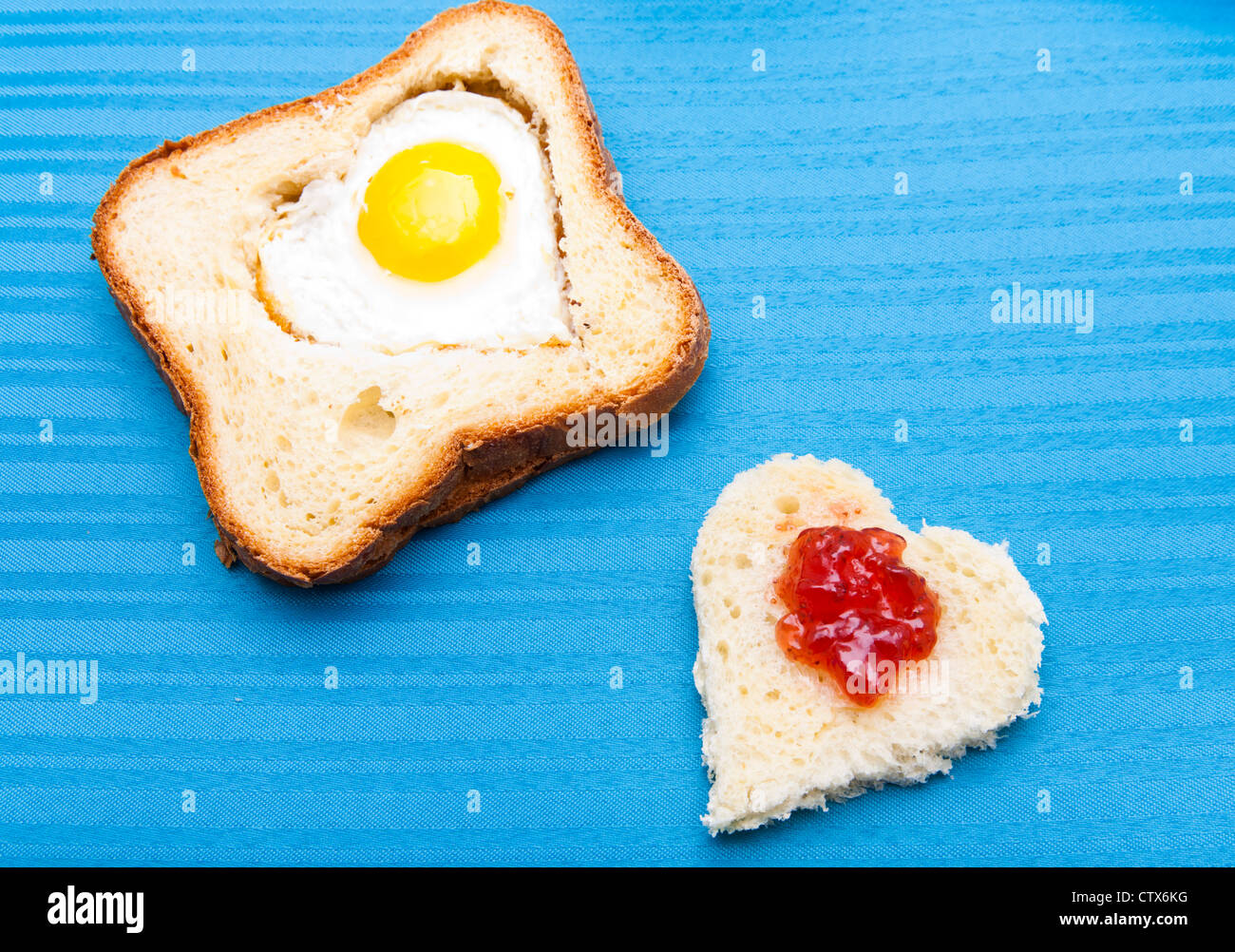 Heart shaped toast on blue background Stock Photo - Alamy