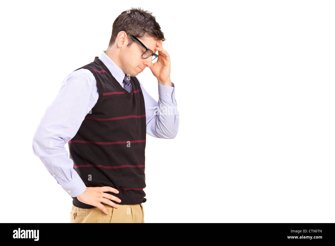 A young male with head down thinking isolated on white background Stock ...