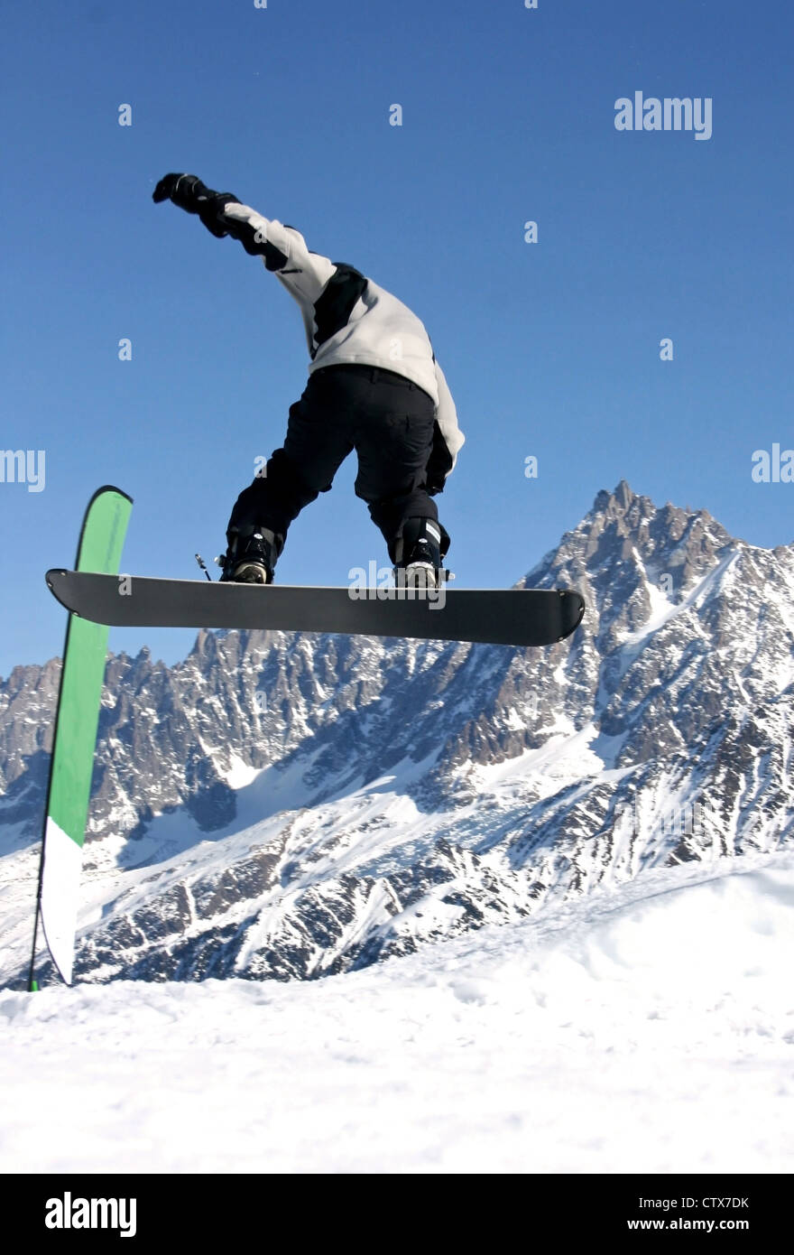 A snowboarder jumping freestyle in the mountains Stock Photo - Alamy