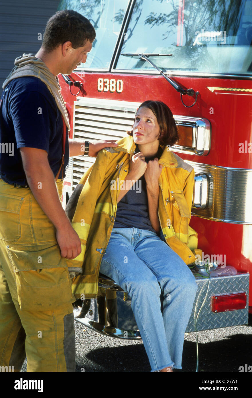 Fireman Comforts Young Fire Rescue Victim Stock Photo - Alamy