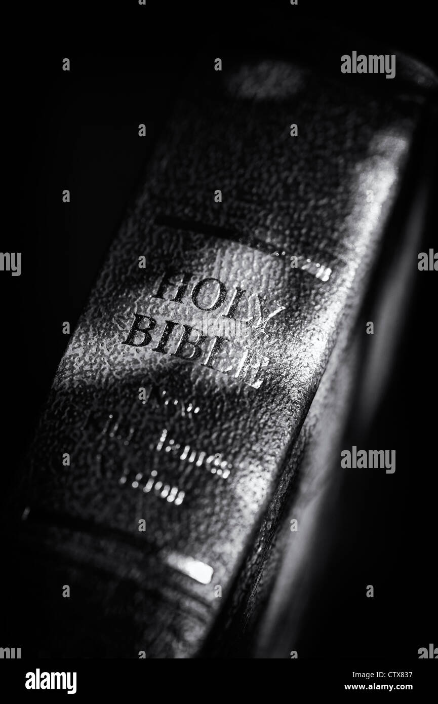 Holy Bible against a dark background. Monochrome Stock Photo - Alamy