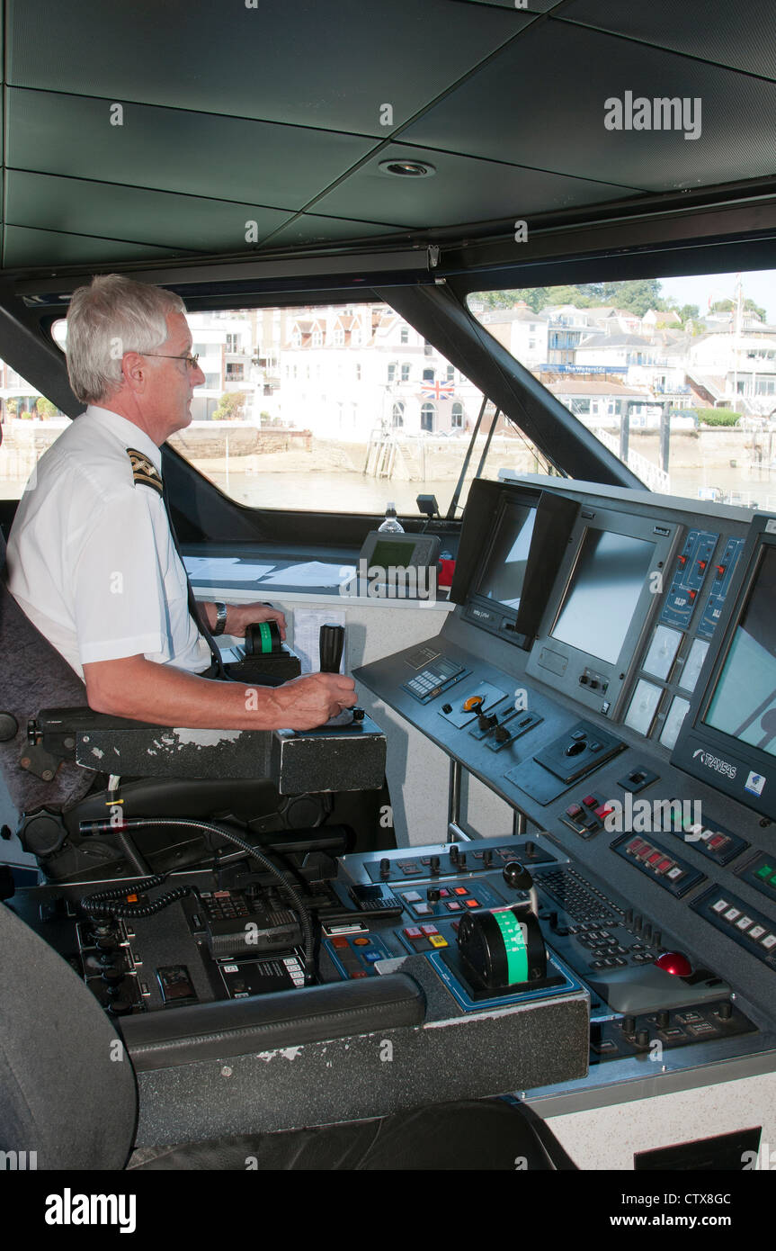 Commander on the bridge of a large passenger catamaran Red Jet 4 of the ...