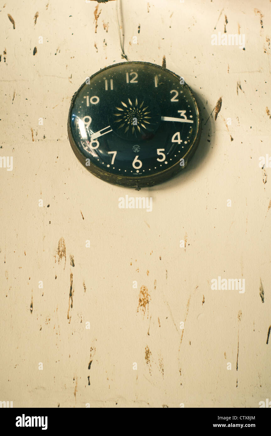 an antique clock on dirty wall, photo is taken at Penang, Malaysia ...