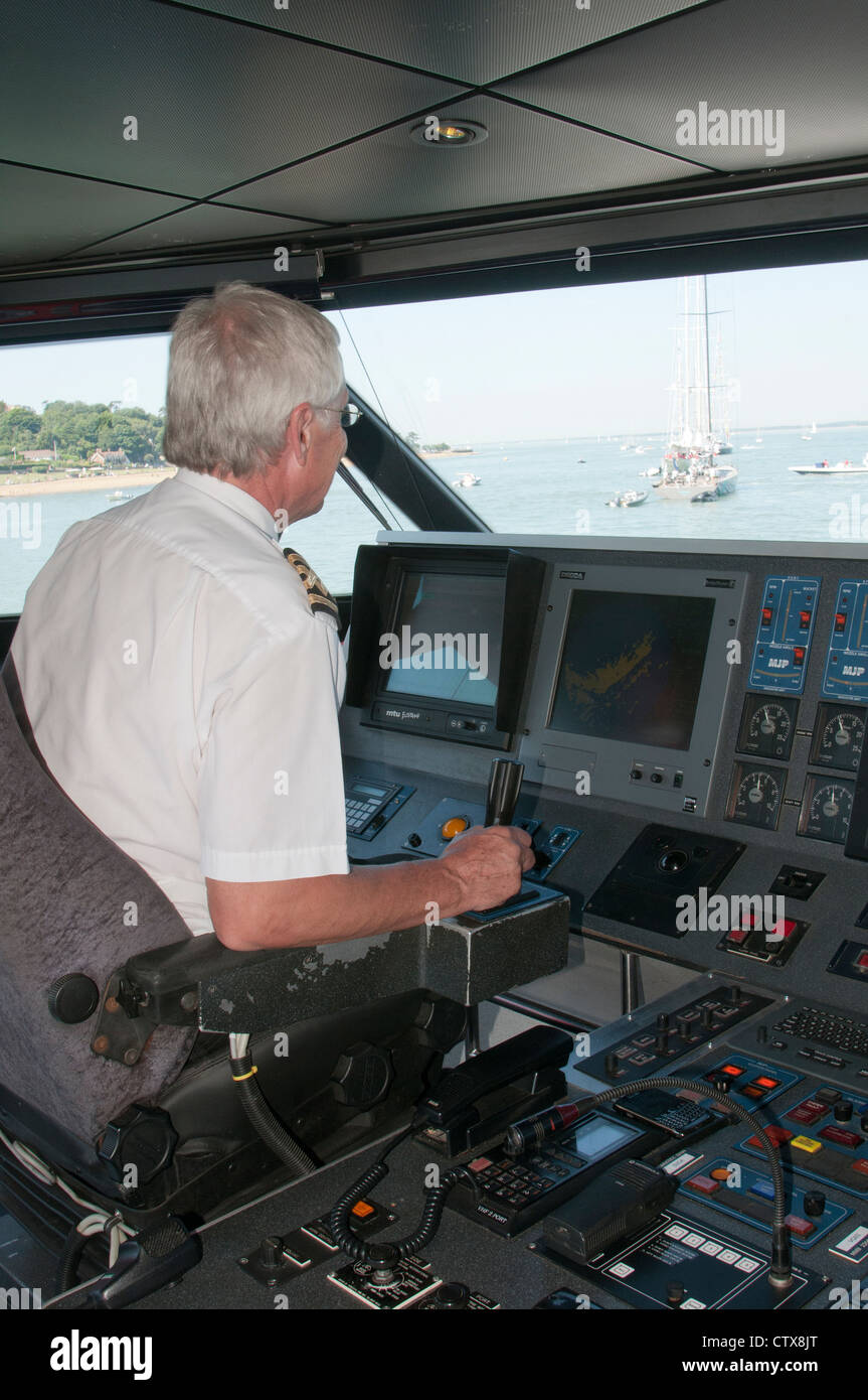 Commander on the bridge of a large passenger catamaran Red Jet 4 of the ...