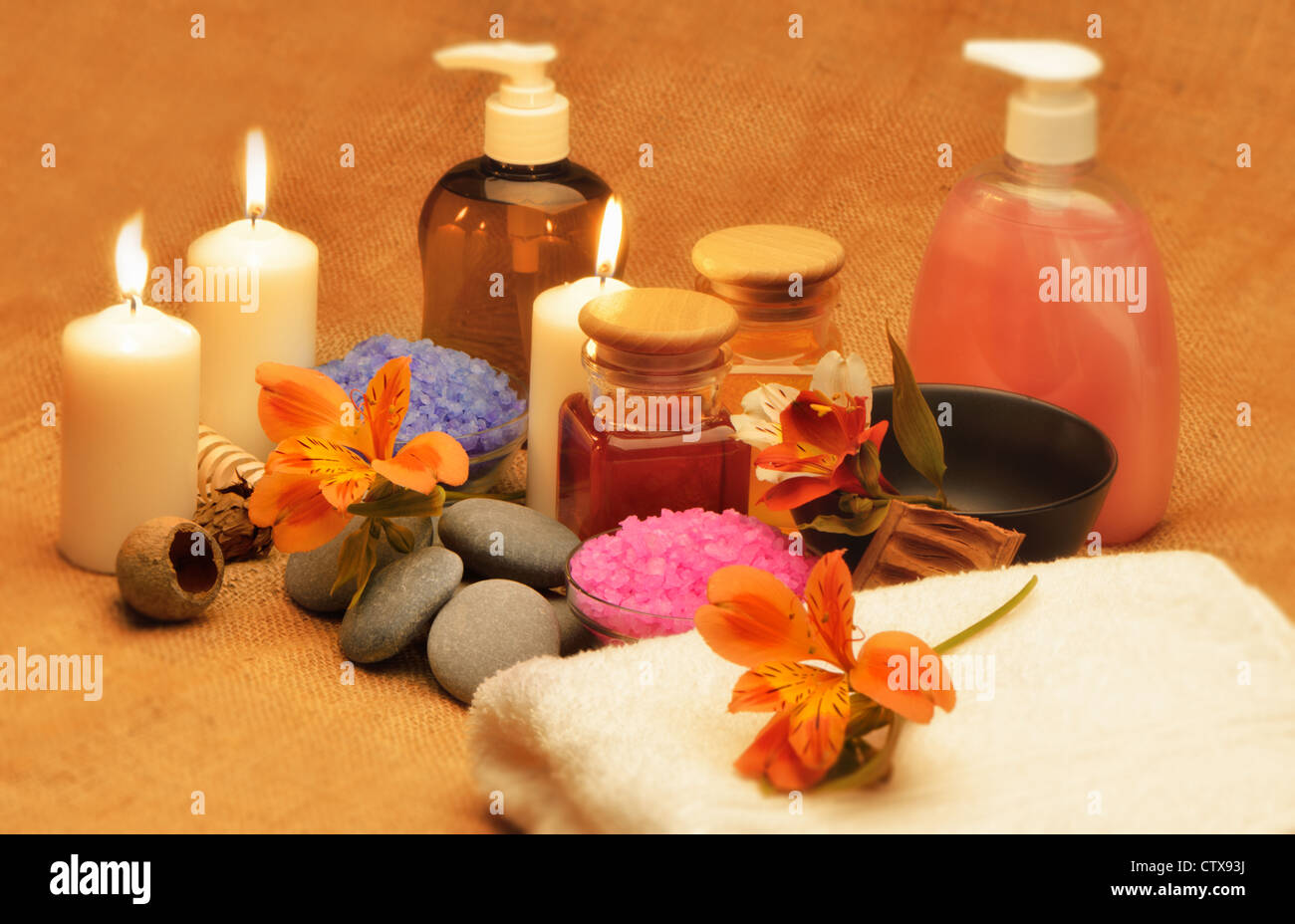 Object for the spa. Candles burning, pebble, a Lily, a bottle with oil ...