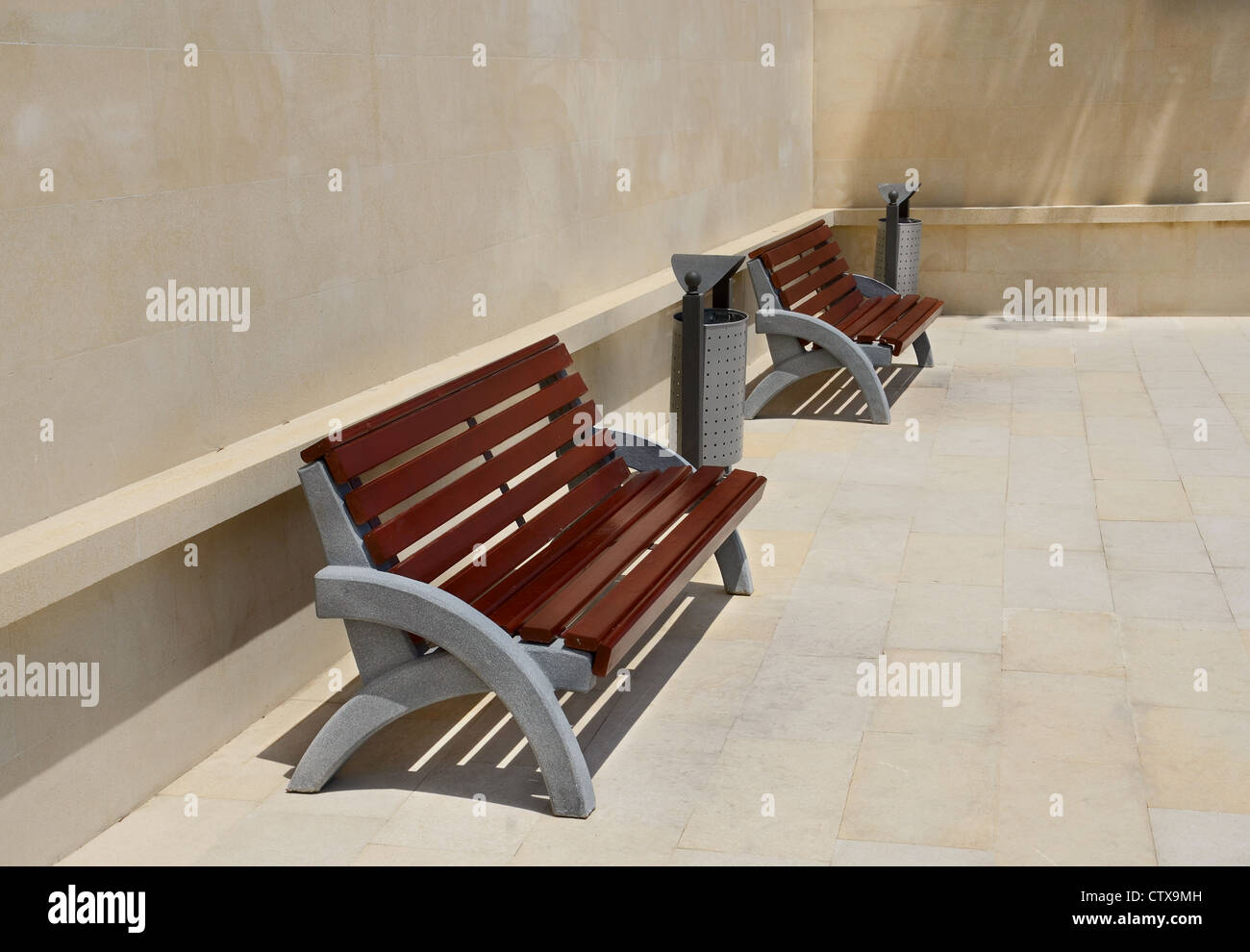 Two empty benches by the wall Stock Photo - Alamy