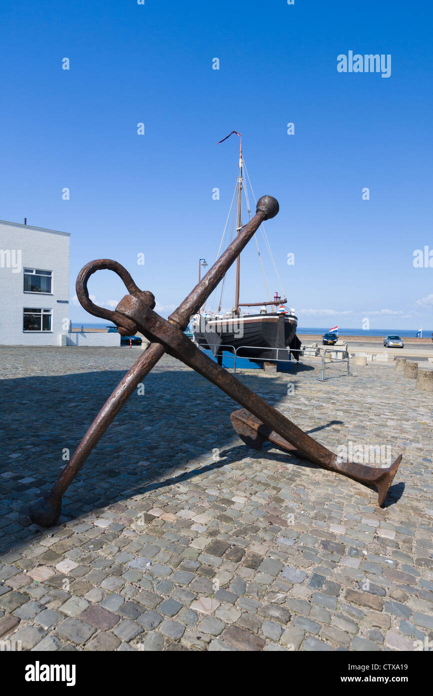 Boat and anchor in front of De Vuurbaak Lighthouse at Katwijk Aan Zee ...
