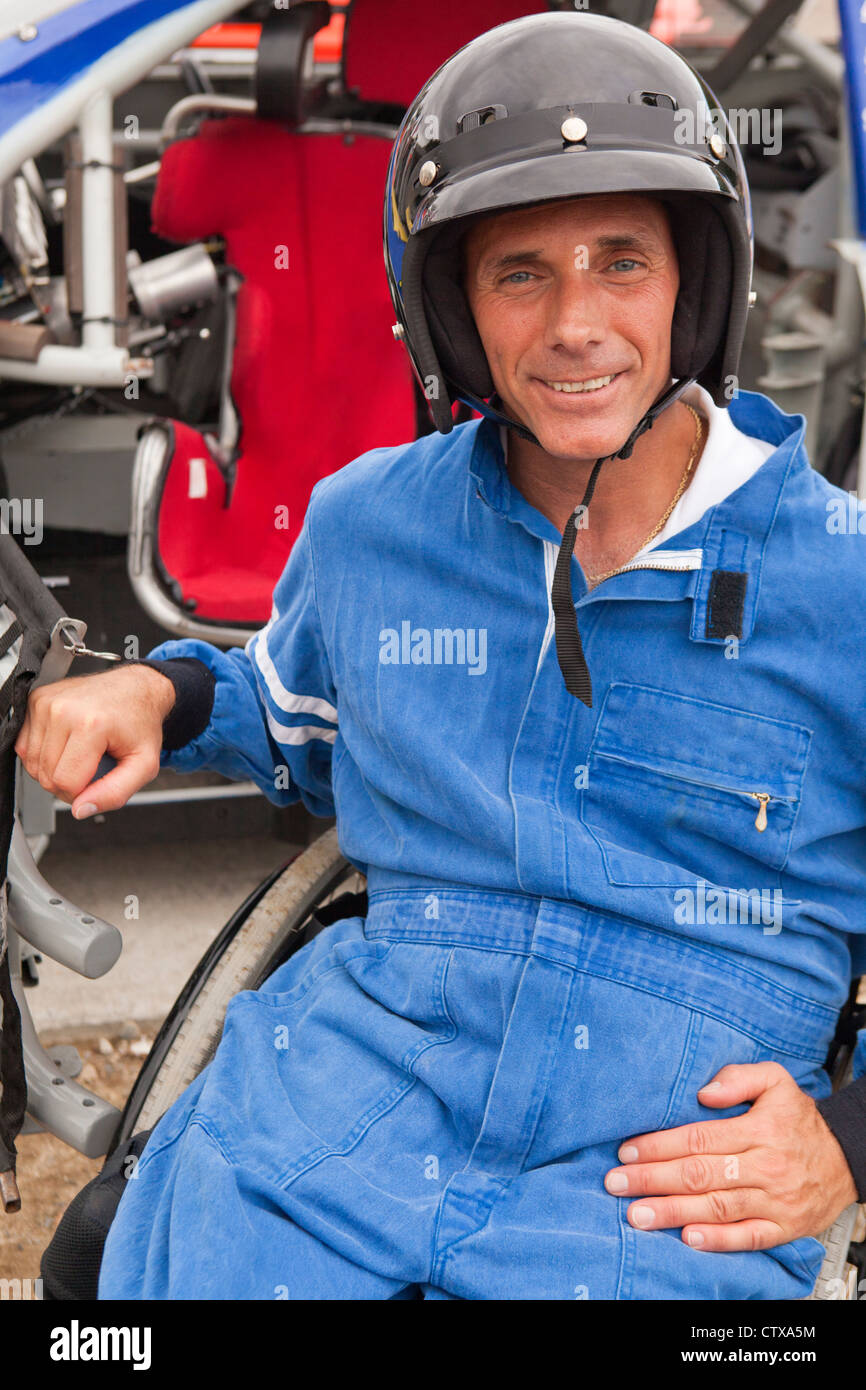 Racer with spinal cord injury in wheelchair with his modified race car ...