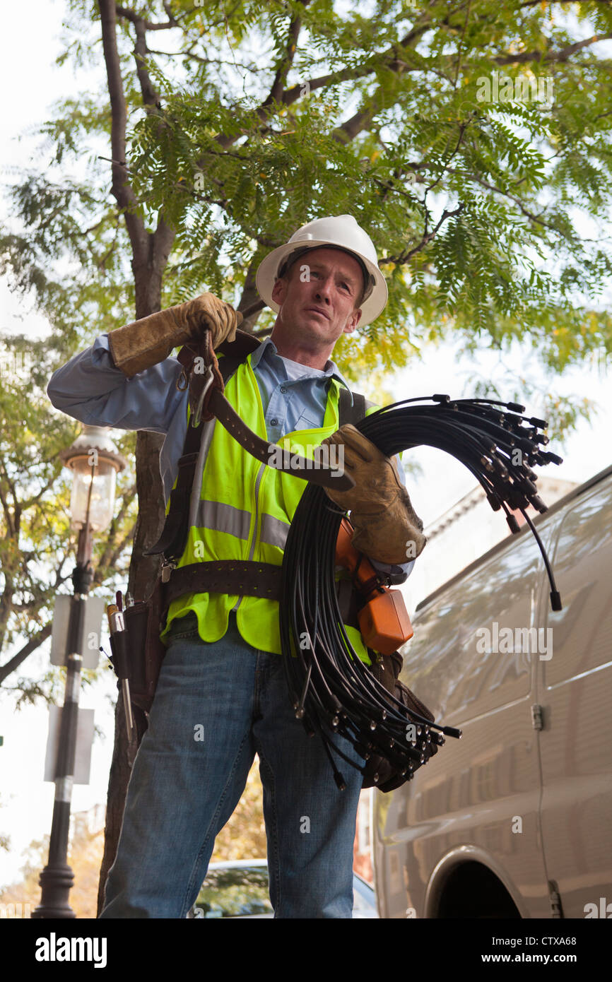 Cable installer carrying short video cables Stock Photo - Alamy