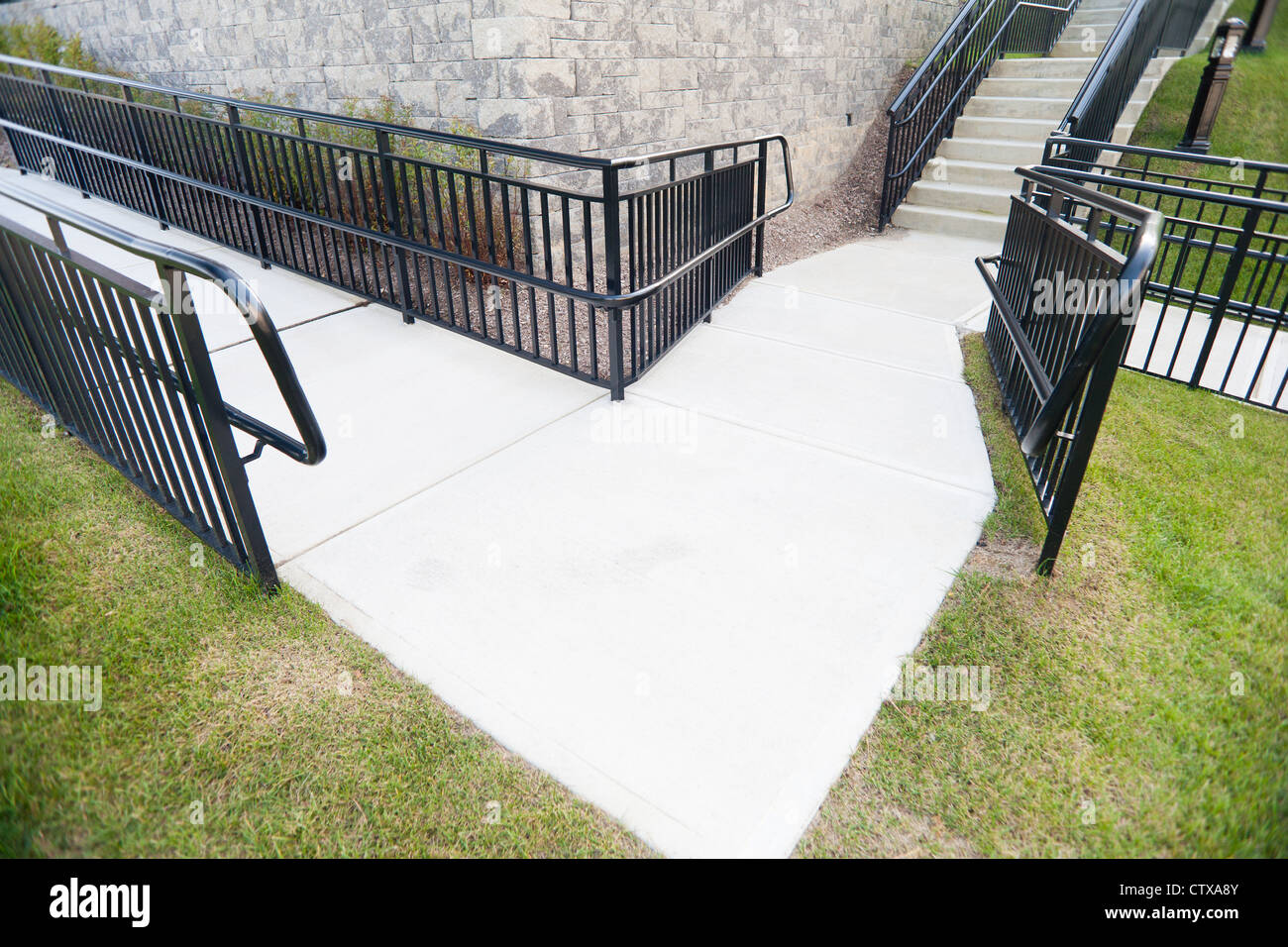 Empty turn in double wheelchair ramp approaching stairs Stock Photo - Alamy