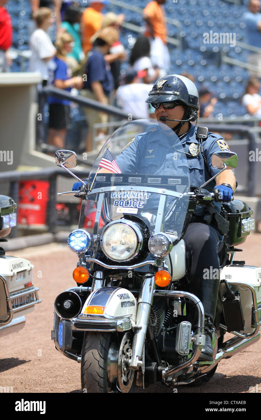 Policeman on motorcycle before game Stock Photo - Alamy