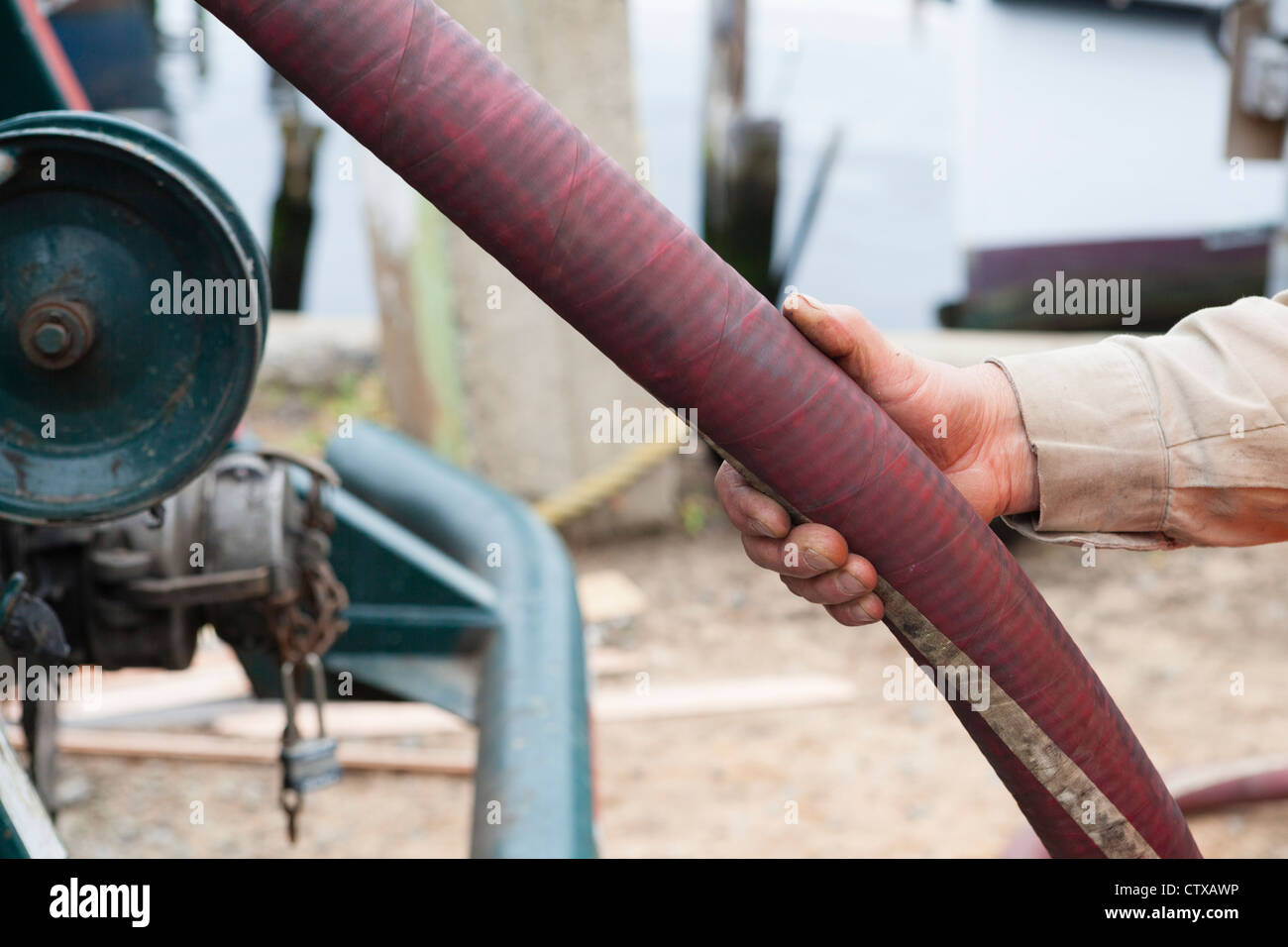 Environmental engineer working on a hose at tanker truck Stock Photo ...