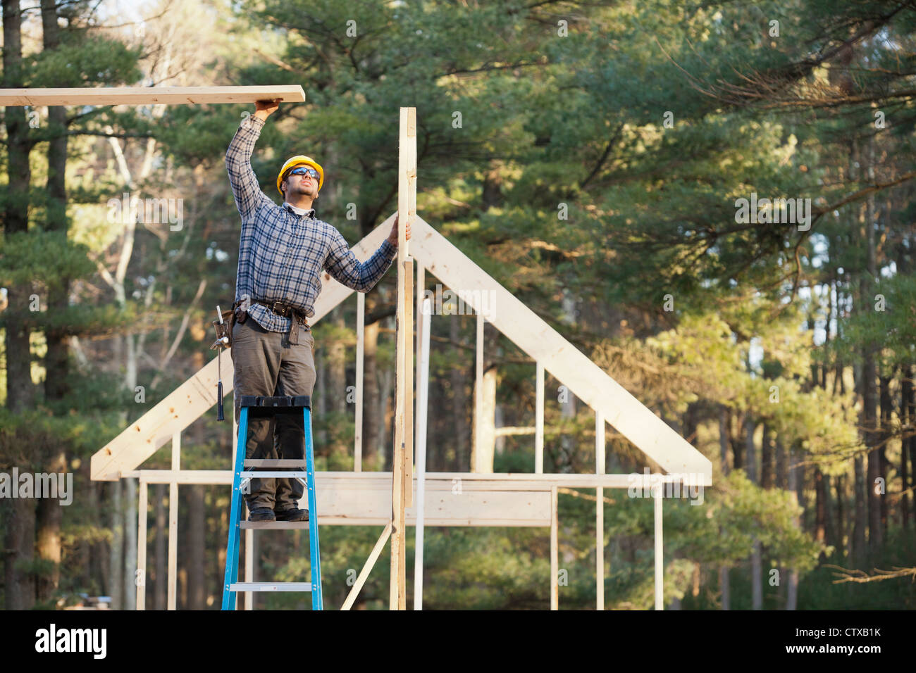 Carpenter assembling roof structure Stock Photo - Alamy