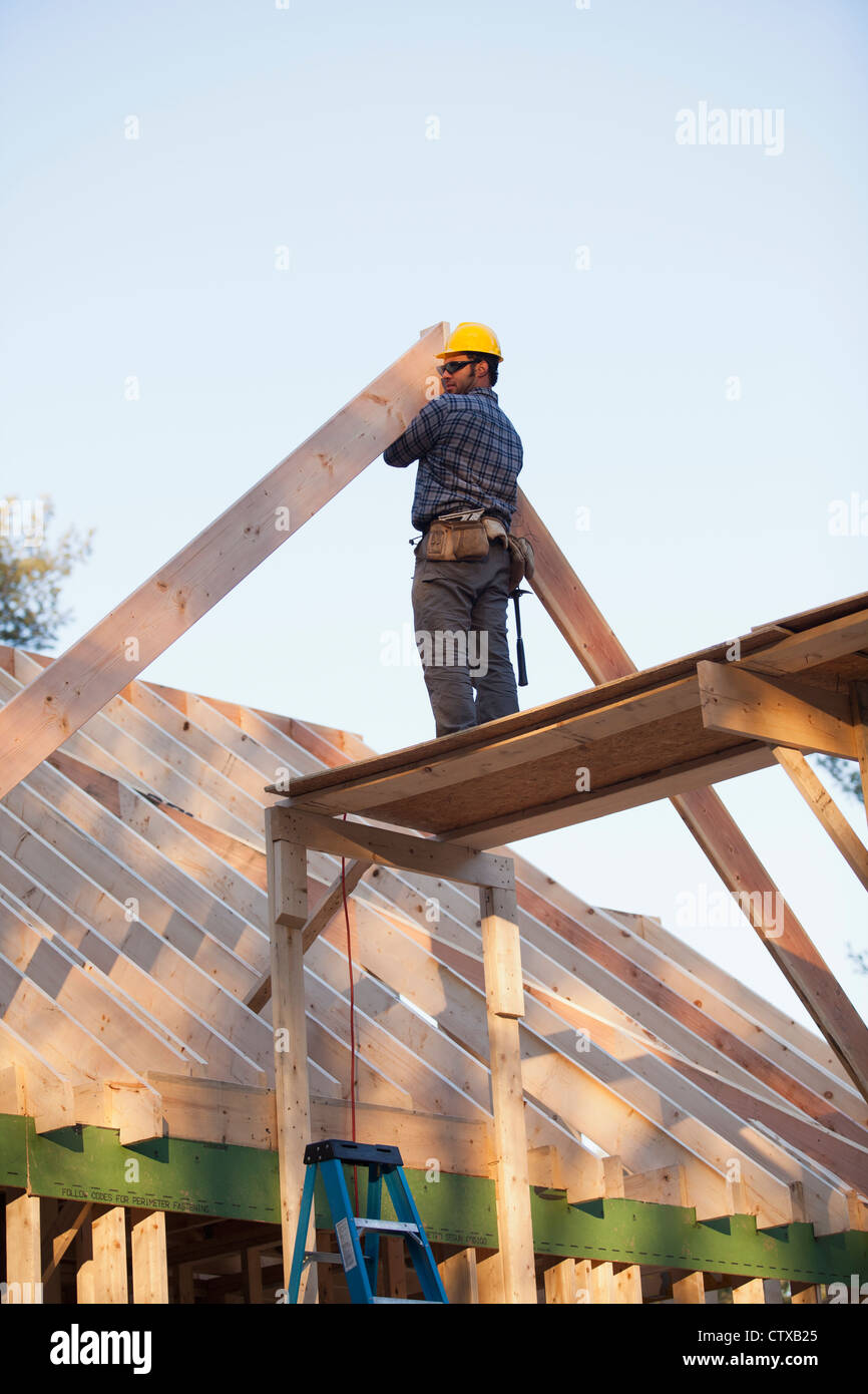 Carpenter placing a rafter Stock Photo - Alamy