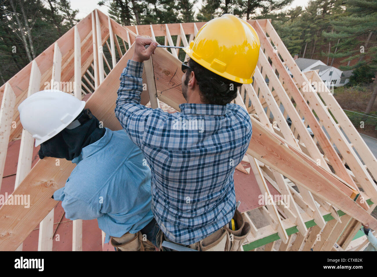 Carpenters working on rafter peak Stock Photo - Alamy