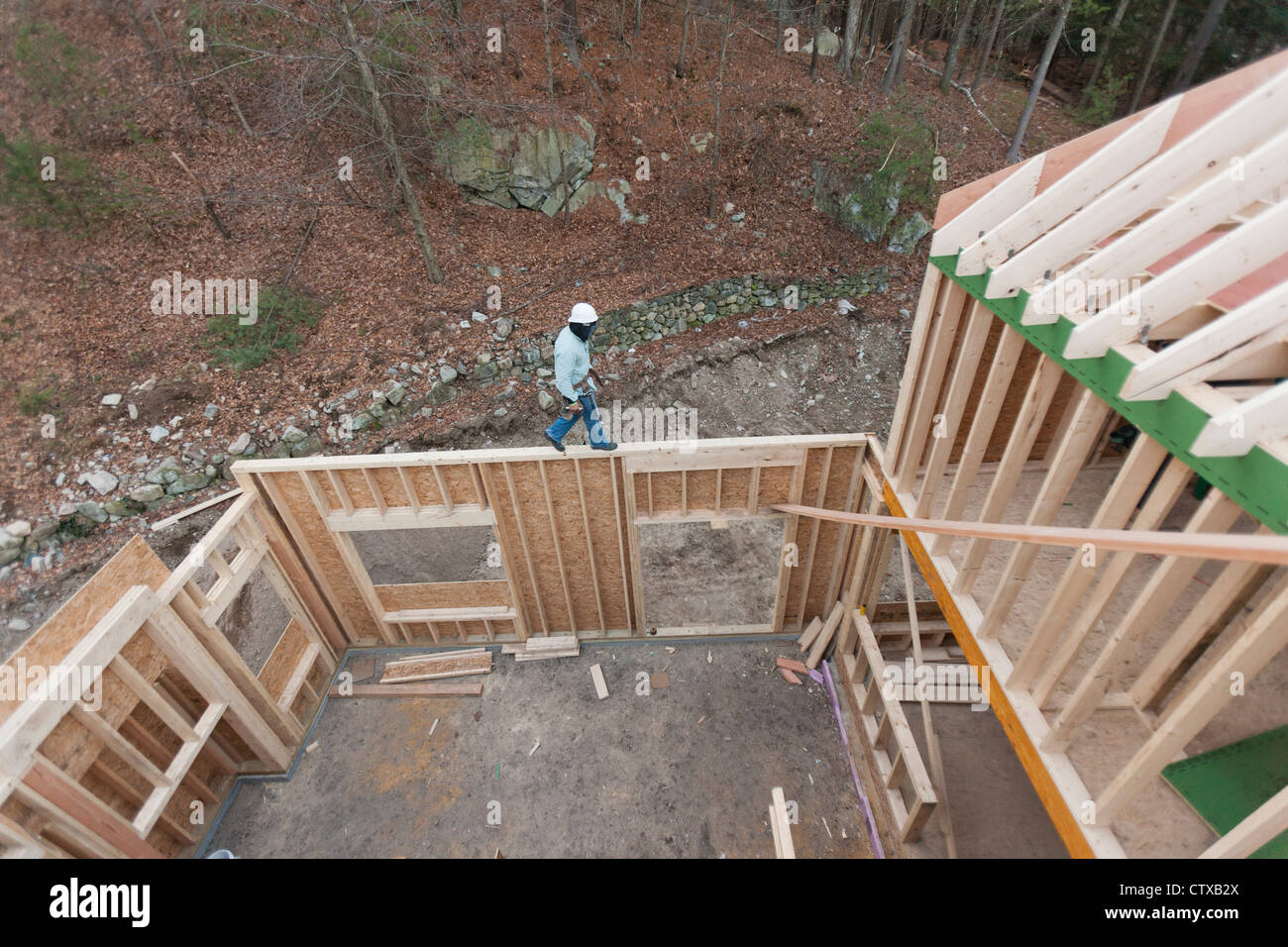 Carpenter walking on a wall frame Stock Photo - Alamy