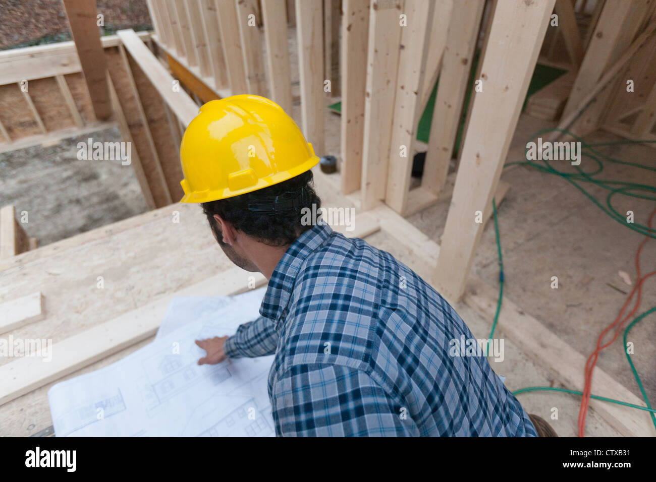Carpenter reviewing house plans Stock Photo - Alamy