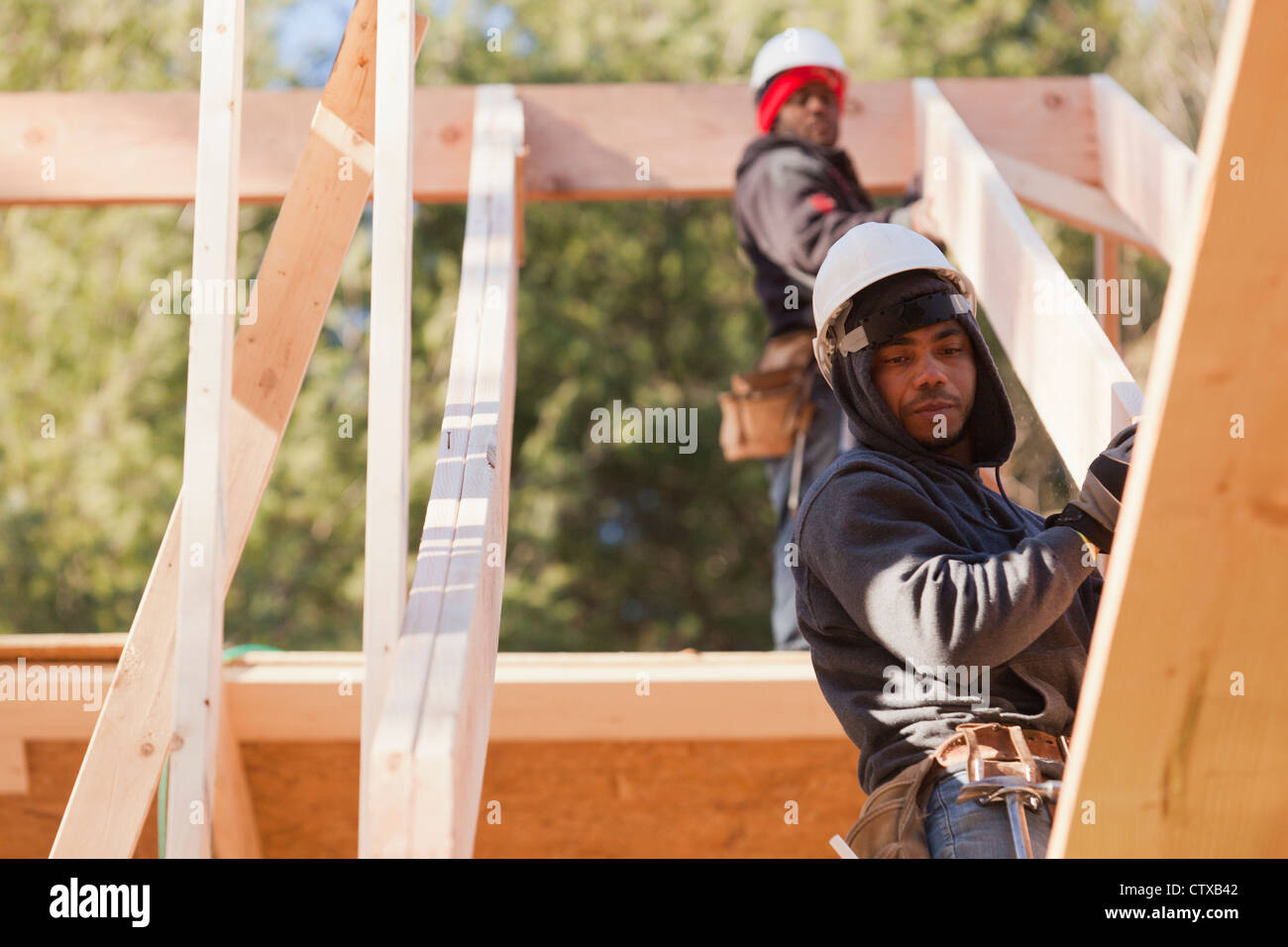 Carpenter placing a roof rafter Stock Photo - Alamy