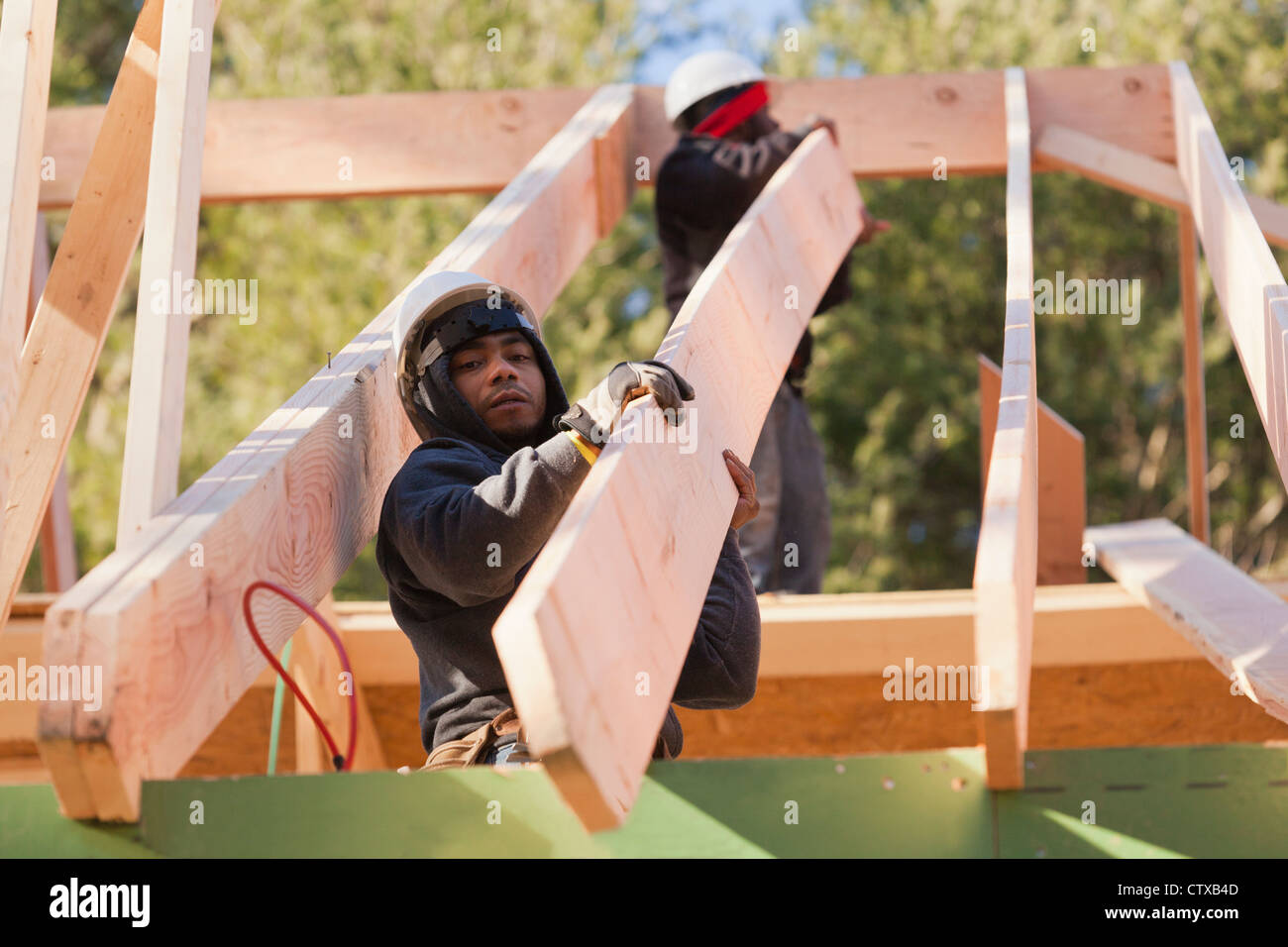 Carpenters placing roof rafter into position Stock Photo - Alamy