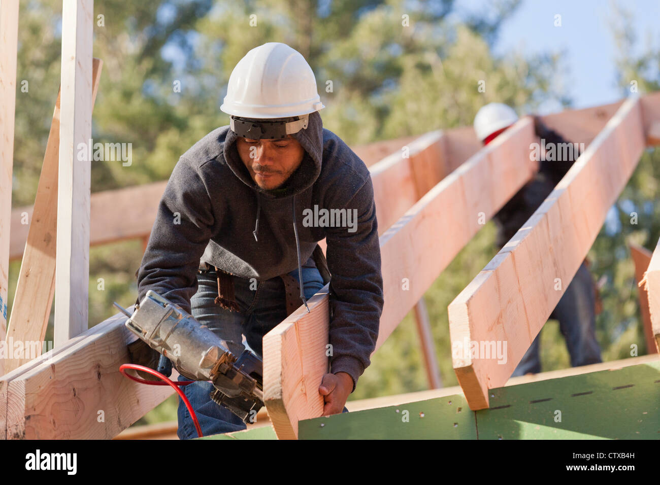 Carpenter nailing a roof rafter Stock Photo - Alamy