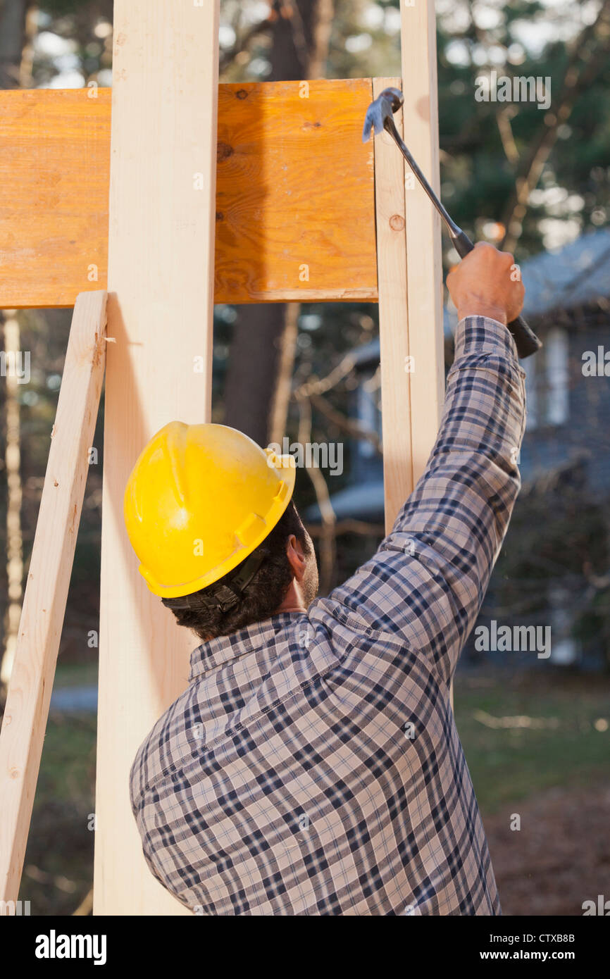 Carpenter using a hammer for final adjustment Stock Photo - Alamy