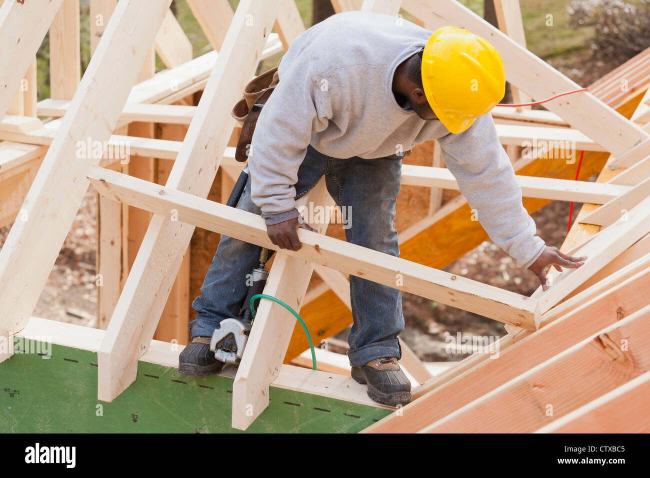 Carpenter placing a rafter for dormer Stock Photo - Alamy