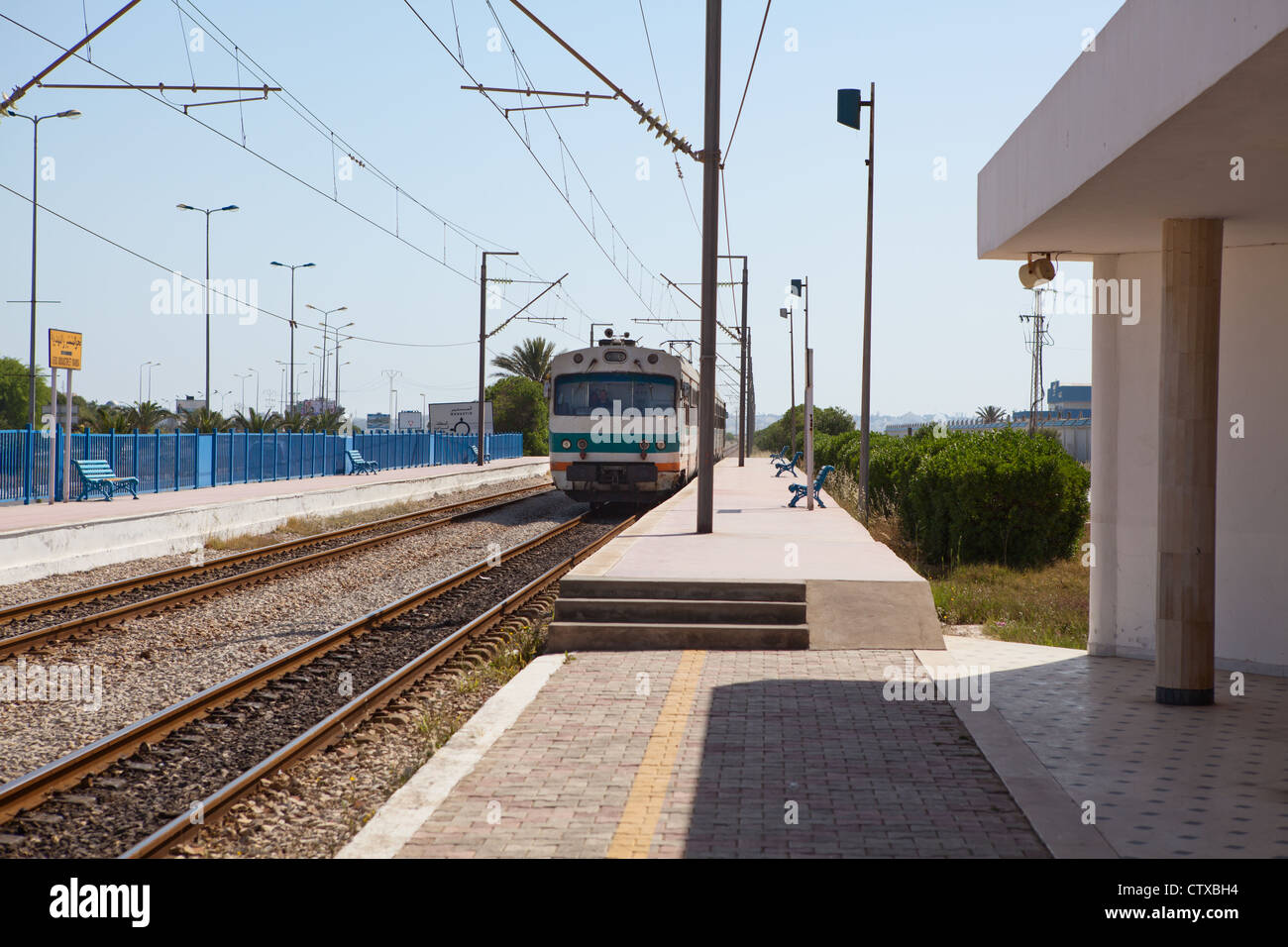 Intercity electric speed train arriving to platform in airport station ...