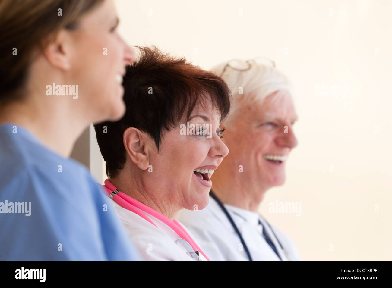 Two nurses and a doctor smiling Stock Photo - Alamy