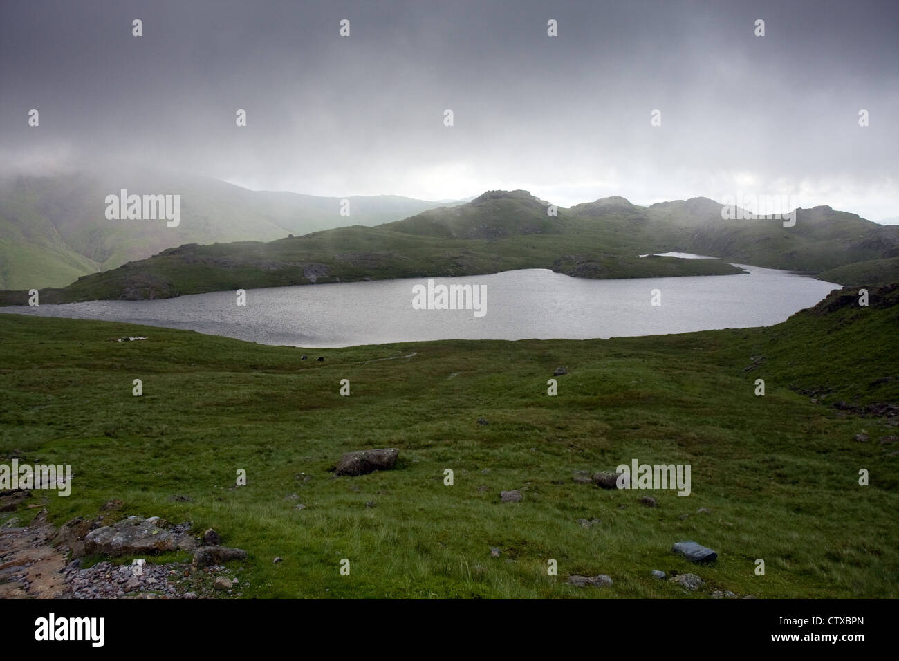 Sprinkling Tarn, in the Lake District, with an early morning cloak of ...