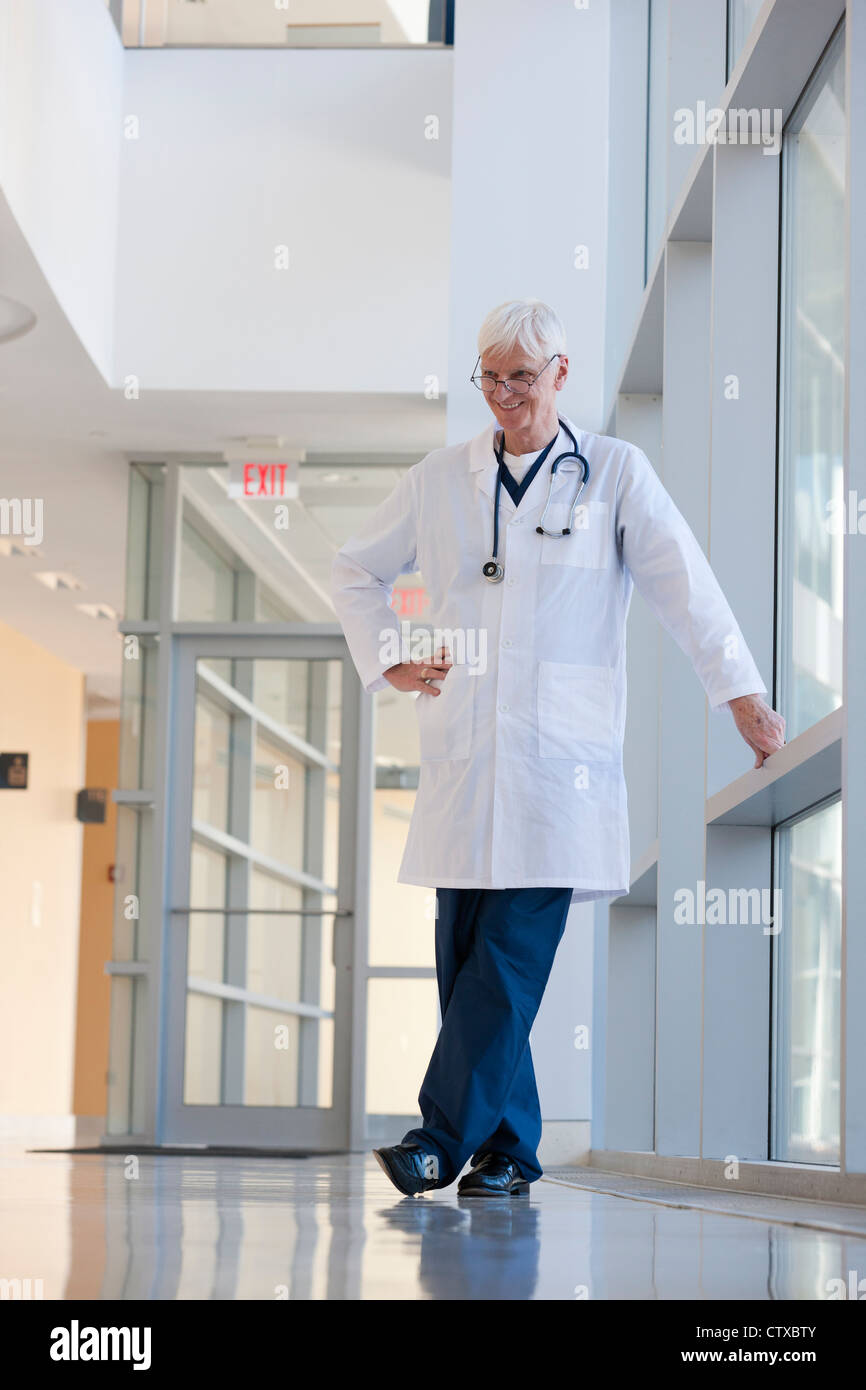 Doctor standing in hospital hallway Stock Photo - Alamy