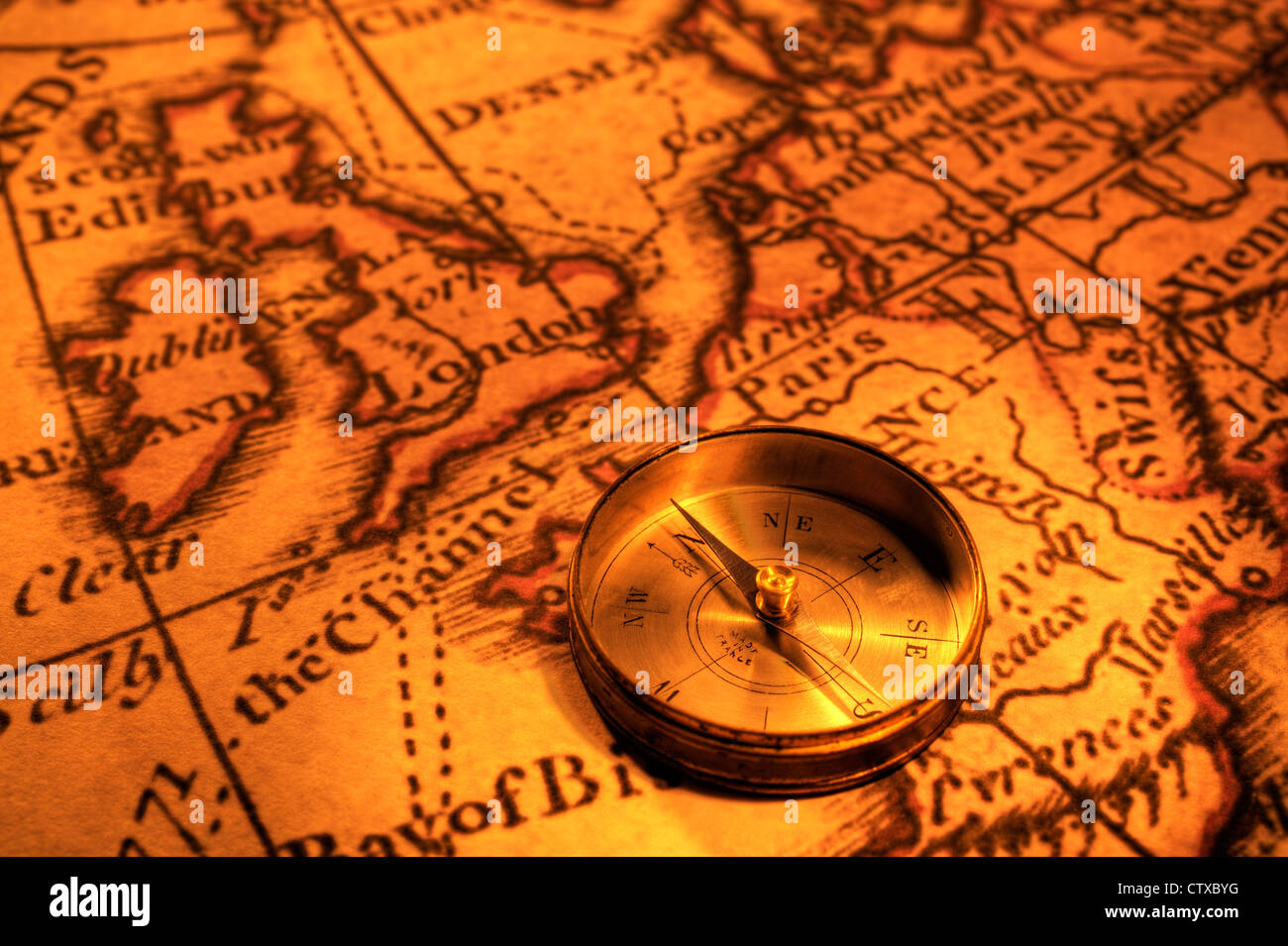 Ancient compass and old map of the UK and Europe, showing London and ...