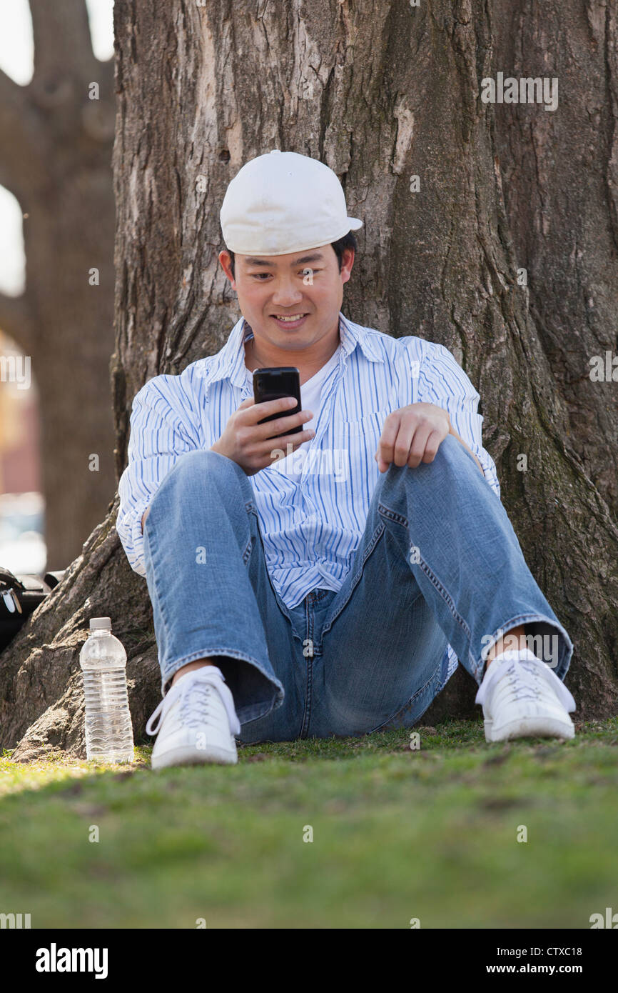 Chinese student reading text messages on cell phone Stock Photo - Alamy